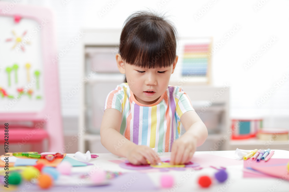 young girl making paper craft for homeschooling Stock Photo | Adobe Stock