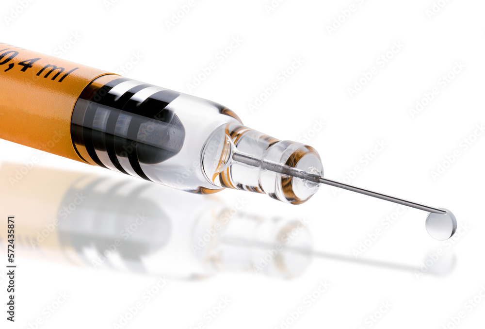 Syringe with a drop on a needle isolated on a white background. A ...