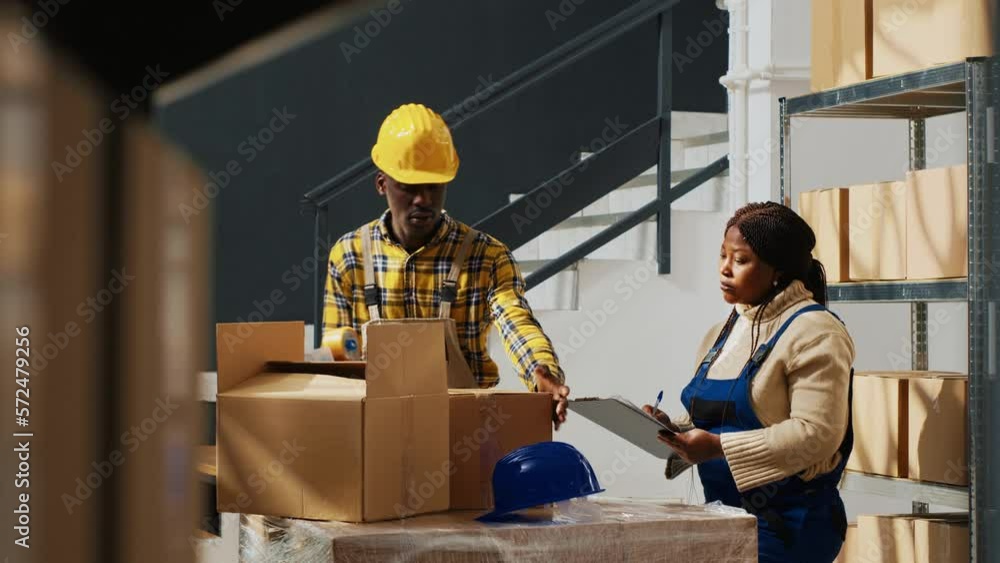 Factory workers packing retail store goods in boxes and preparing ...