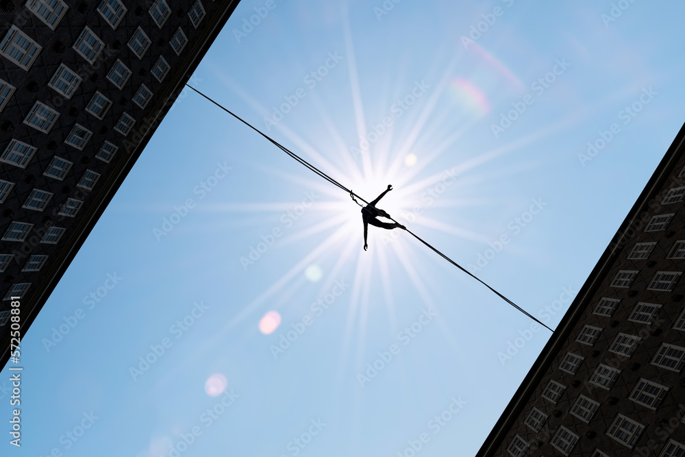 Man balancing on the rope challenge and risk taking concept Stock Photo ...