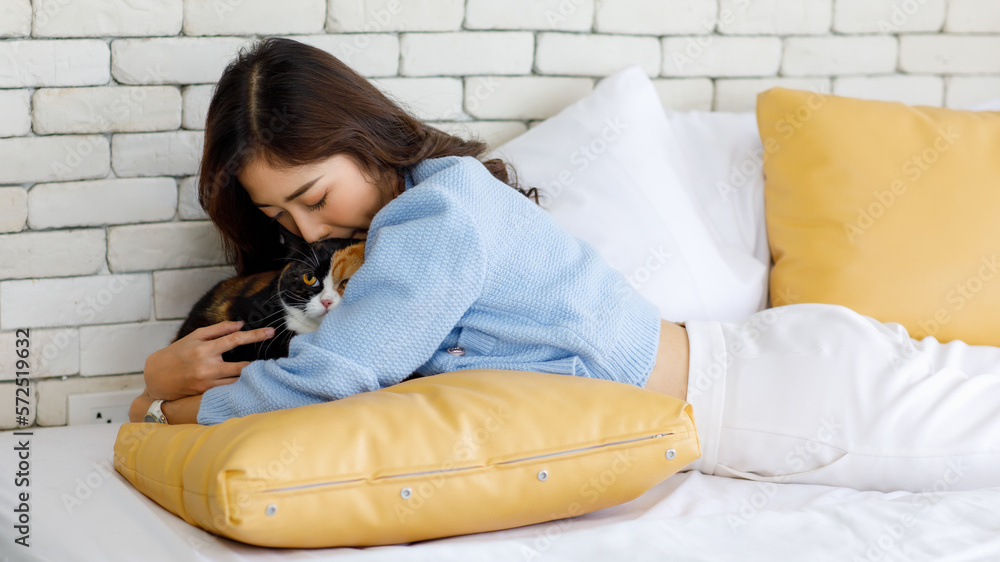 Millennial Asian young kindly cheerful female owner laying lying down ...