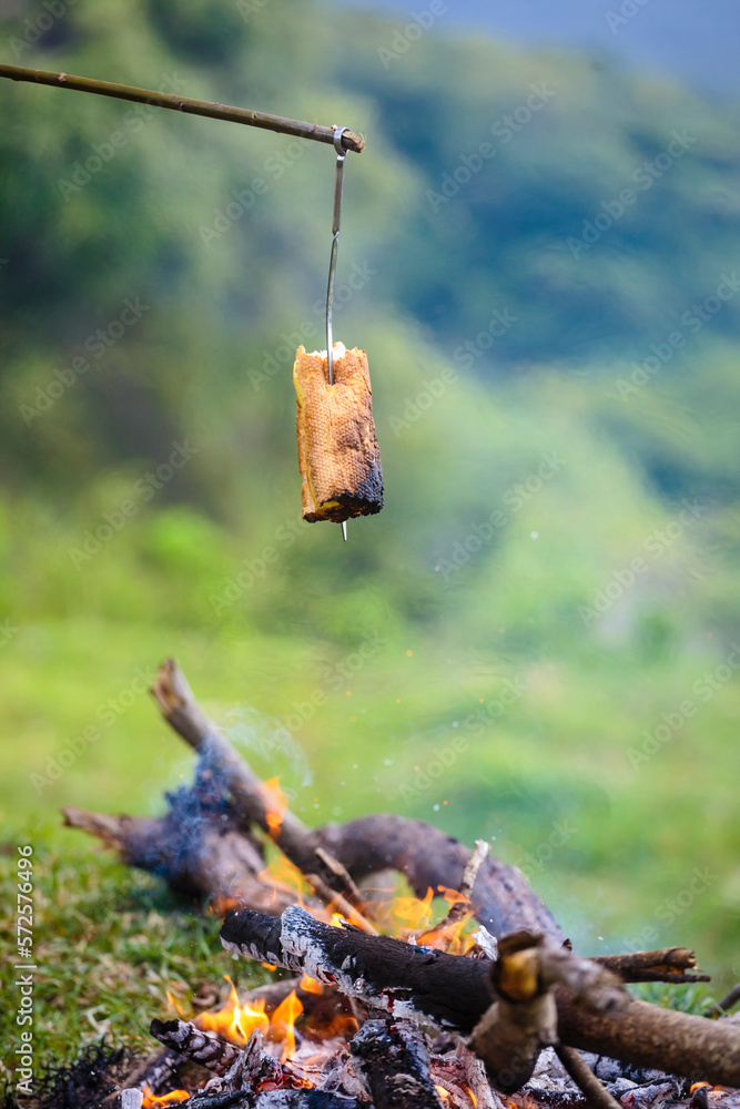 Bread toasting over campfire, Nusa Penida, Bali, Indonesia Stock Photo ...