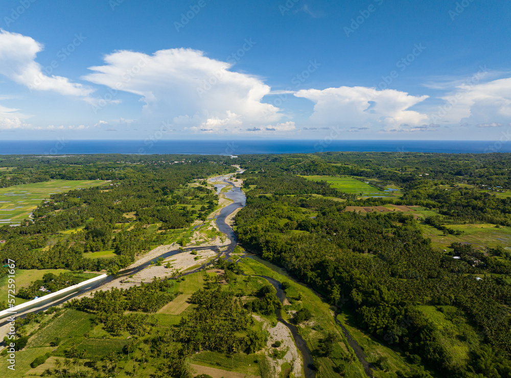 River among agricultural land and rice fields in the tropics. Negros ...