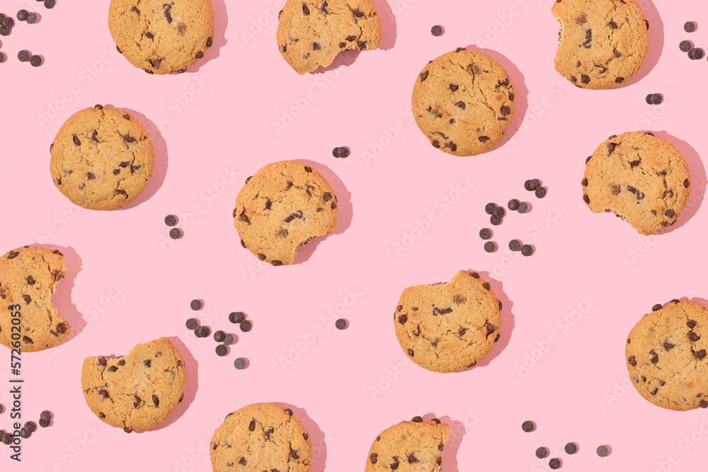 Creative pattern with cookies and chocolate chips on pastel pink ...