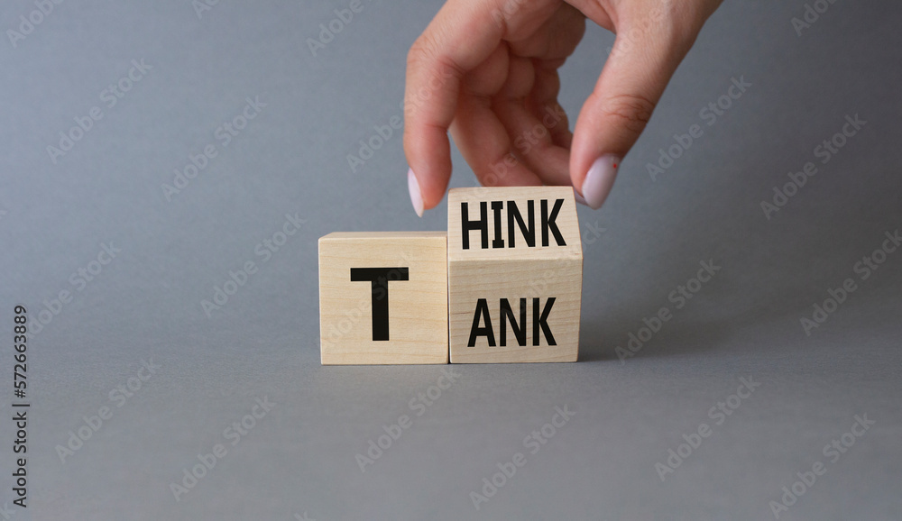 Think Tank symbol. Businessman hand Turnes cubes with words Think Tank. Beautiful grey ...