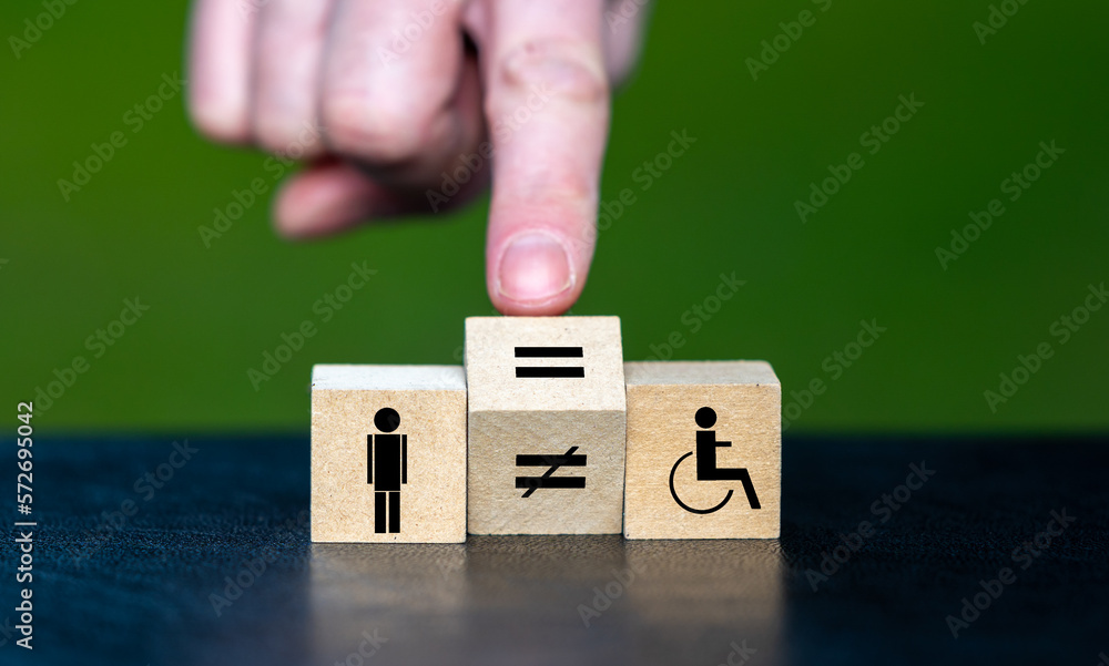 Symbol for equal rights of persons with disabilities. Hand turns wooden ...