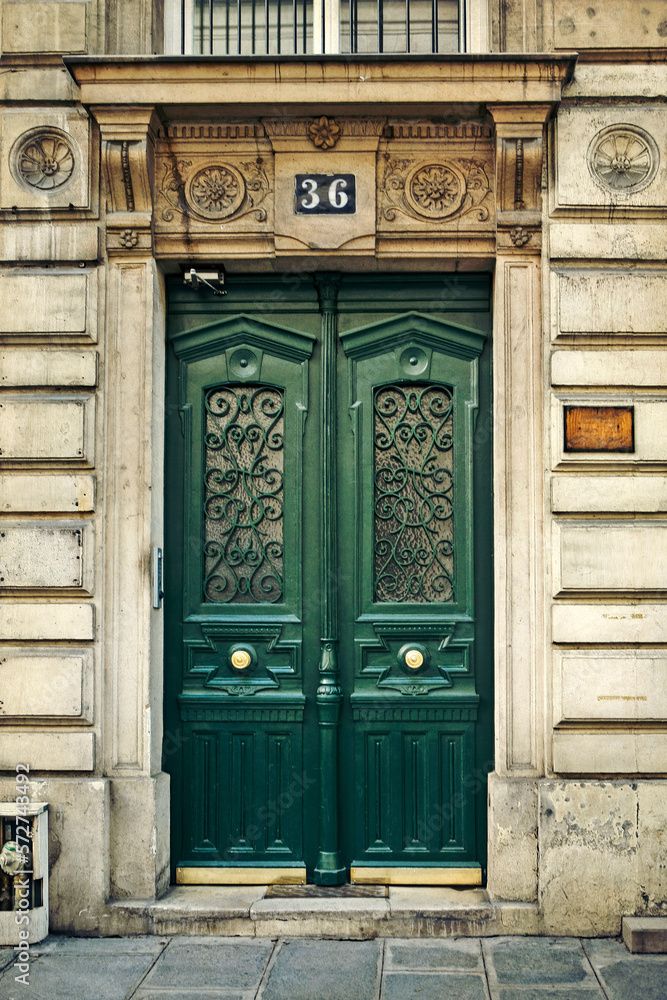 Paris ancient stone building entrance with wooden carved double doors ...