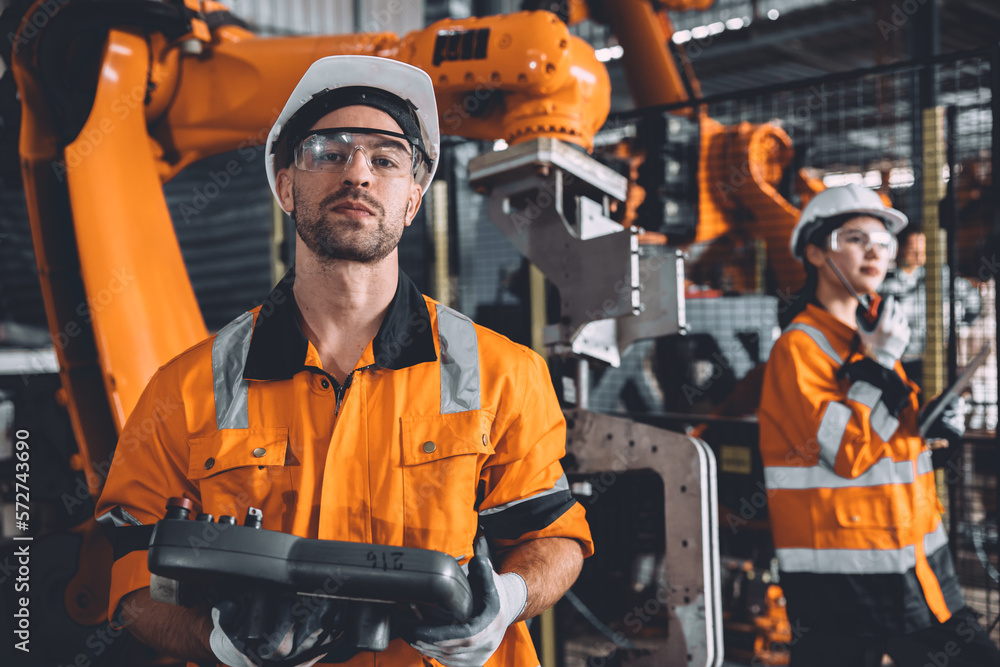 Engineer team service robot welding working in automation factory ...
