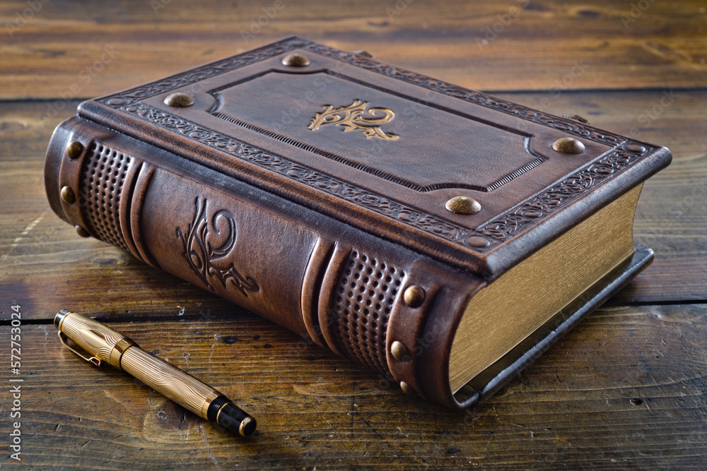 Aged brown leather book with the Eye of Horus in the center of the ...