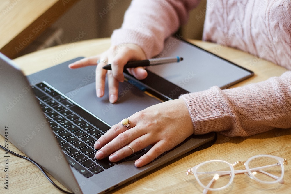 Young Woman Designing with Laptop and Graphics Tablet This striking ...