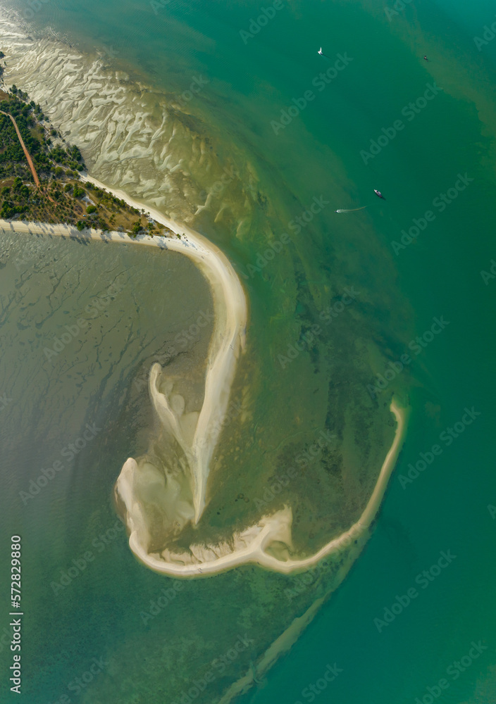 aerial top view above sandbar stretches down into the sea during low ...