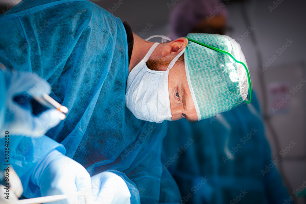 Surgical resident performinga neurosurgical operation Stock Photo ...