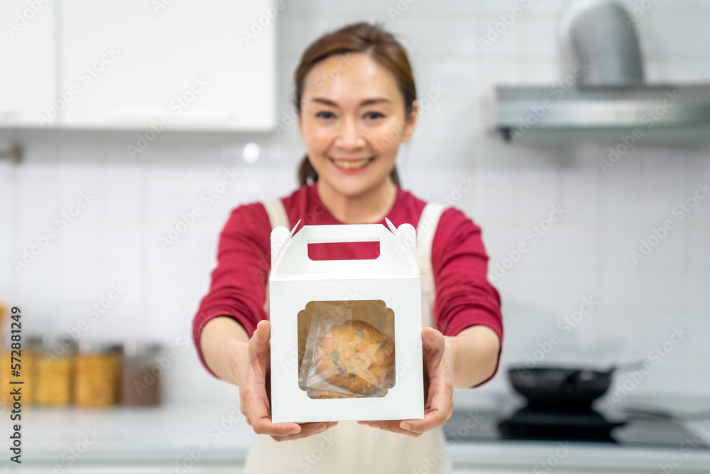 Happy Asian woman bakery shop owner holding cookies in delivery box for ...