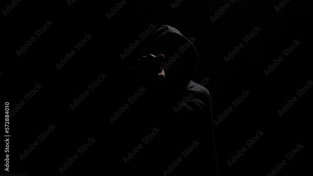 Video „Isolated portrait mysterious figure in black hoodie, pointing at ...