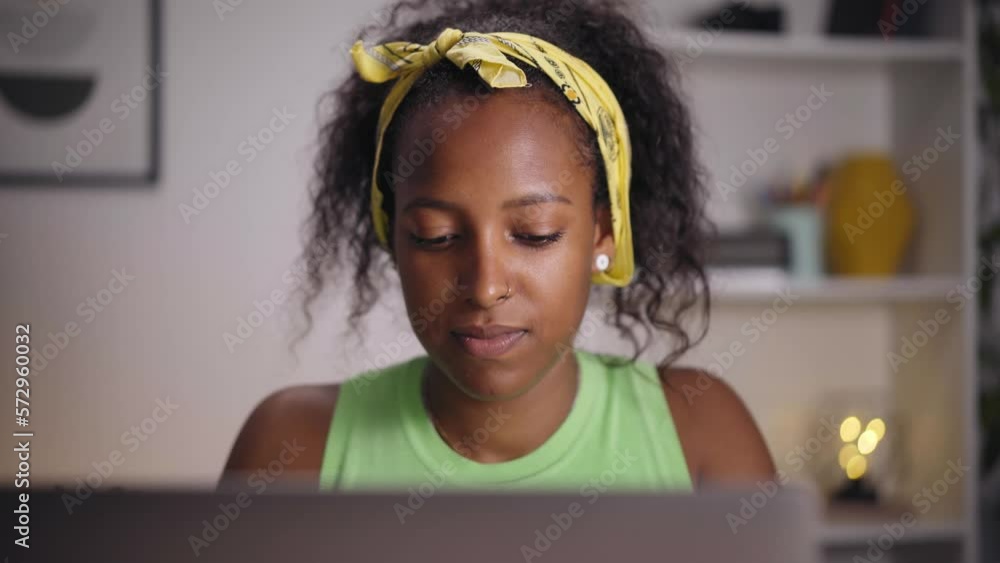 Video close up young American woman using laptop in home office. Happy ...