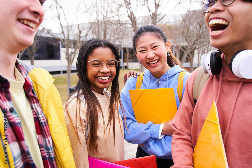 Portrait of four international students with beaming smiles posing for ...