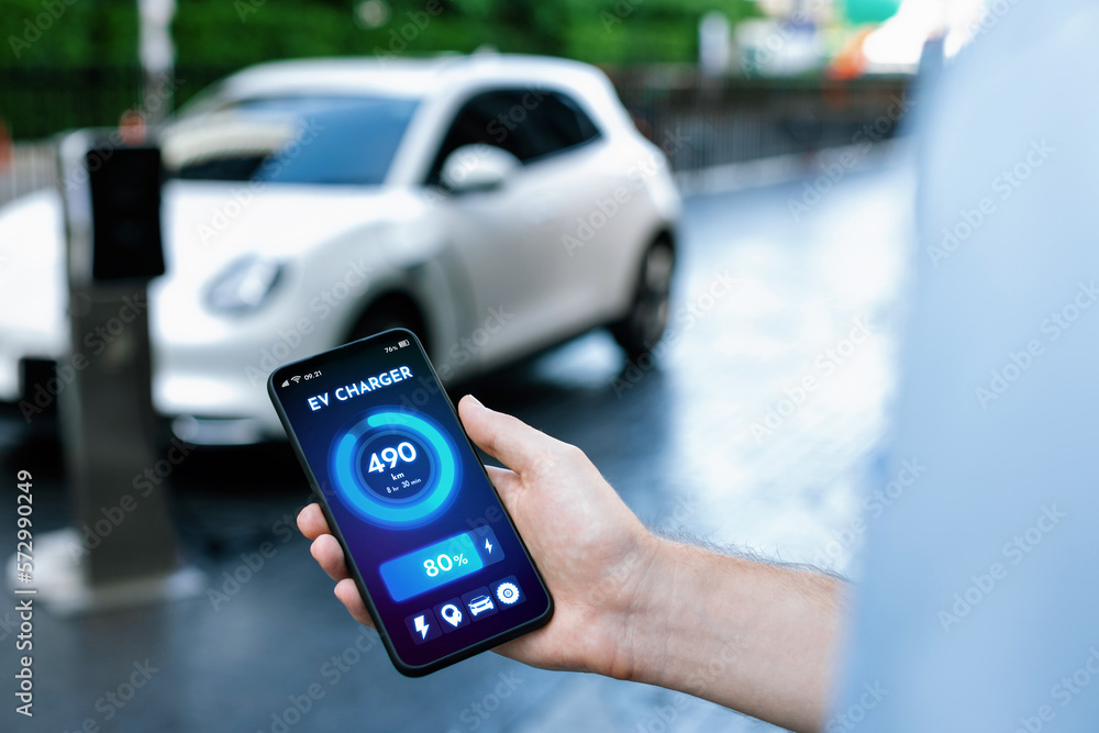 Closeup progressive businessman look at EV car's battery status ...