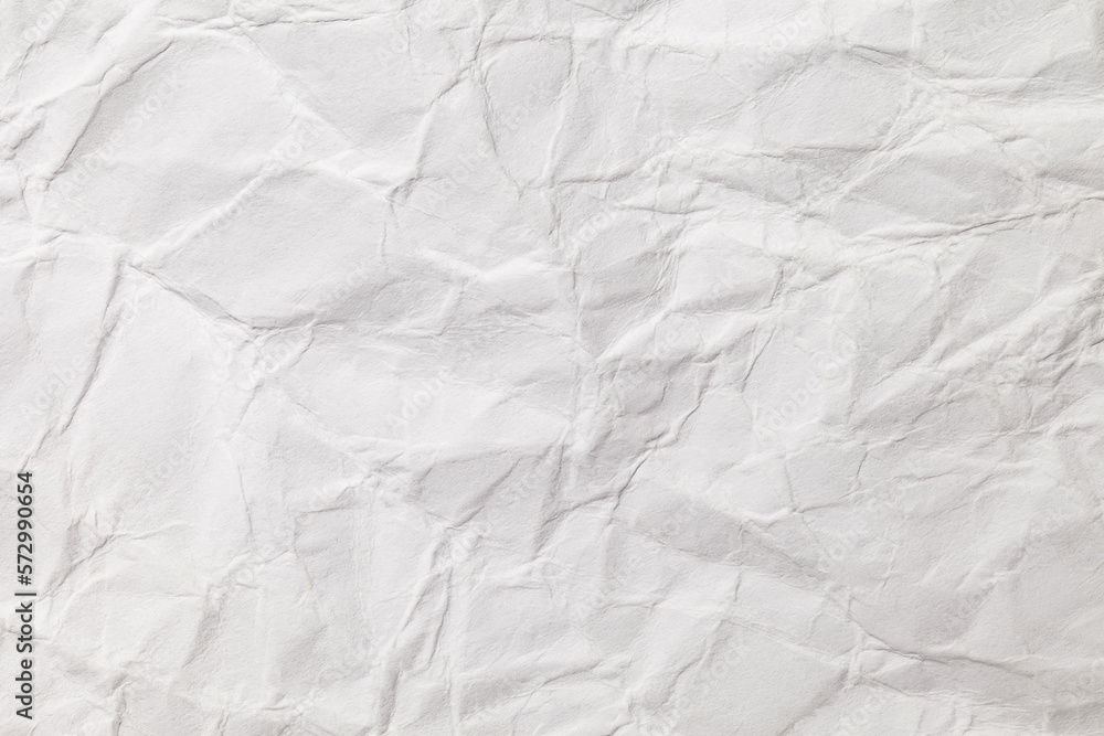 Crumpled white paper wrapping with corrugations and fractures, uneven ...