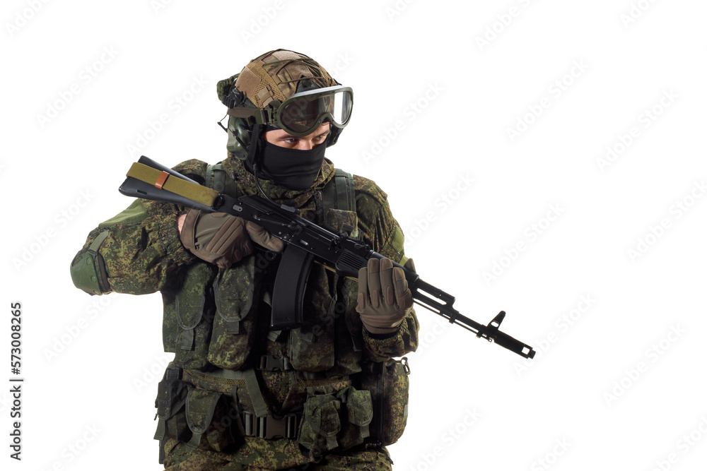 Russian soldier mercenary with a machine gun carefully looks to the ...