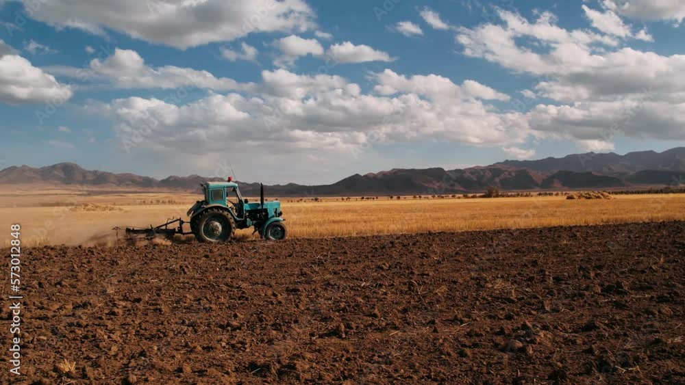 Tractor Plowing field, drone view. Cultivated and soil tillage. Tractor ...