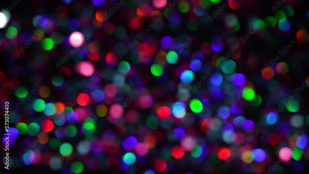 Multicolor blurry dots of light appear with fading on black. Real Lens ...