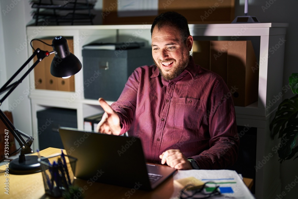 Plus size hispanic man with beard working at the office at night ...