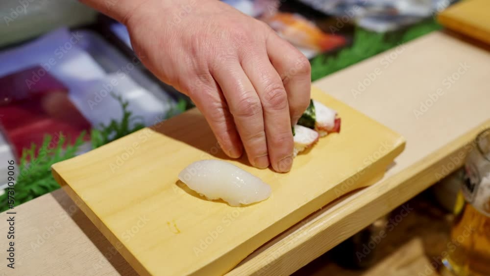 Japanese chef preparing traditional Japanese food octopus sushi in open ...