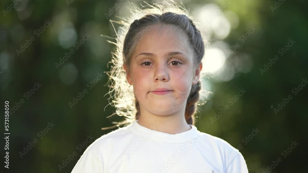 Happy girl in rays of the sun. Girl face in park close-up. Dream girl ...