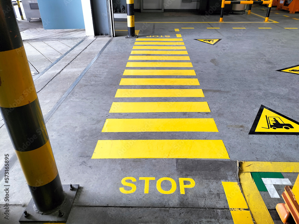 Industrial building corridor painted yellow between parallel yellow ...