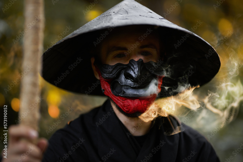 Surrealism theme: a man in a hannya mask, black kimono, black hat with ...