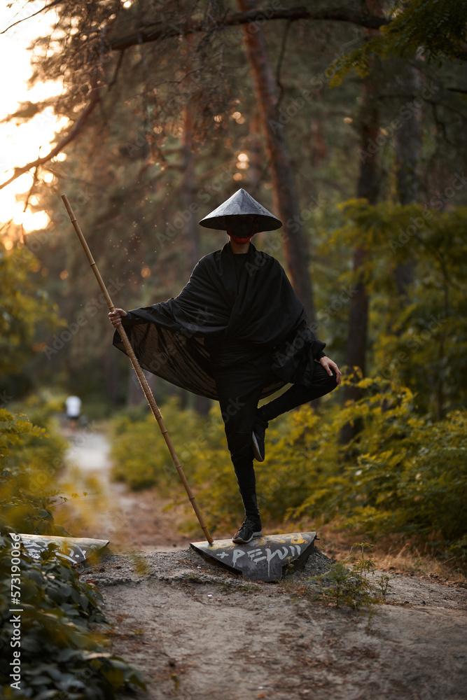 Surrealism theme: a man in a hannya mask, black kimono, black hat with ...