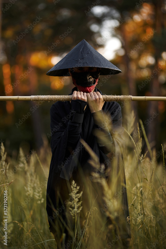 Surrealism theme: a man in a hannya mask, black kimono, black hat with ...