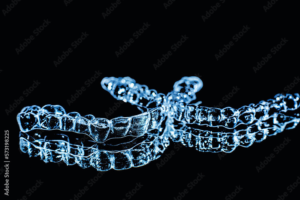 Invisible dental teeth brackets tooth aligners on black background ...