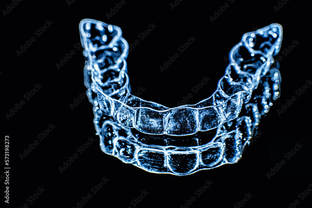 Invisible dental teeth brackets tooth aligners on black background ...