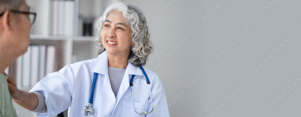 Expert Asian senior female doctor talking with her male patient show ...