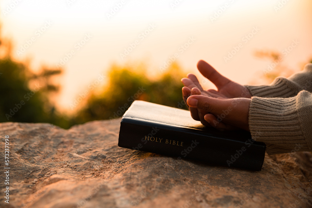 Silhouette of woman kneeling down praying for worship God at sky ...