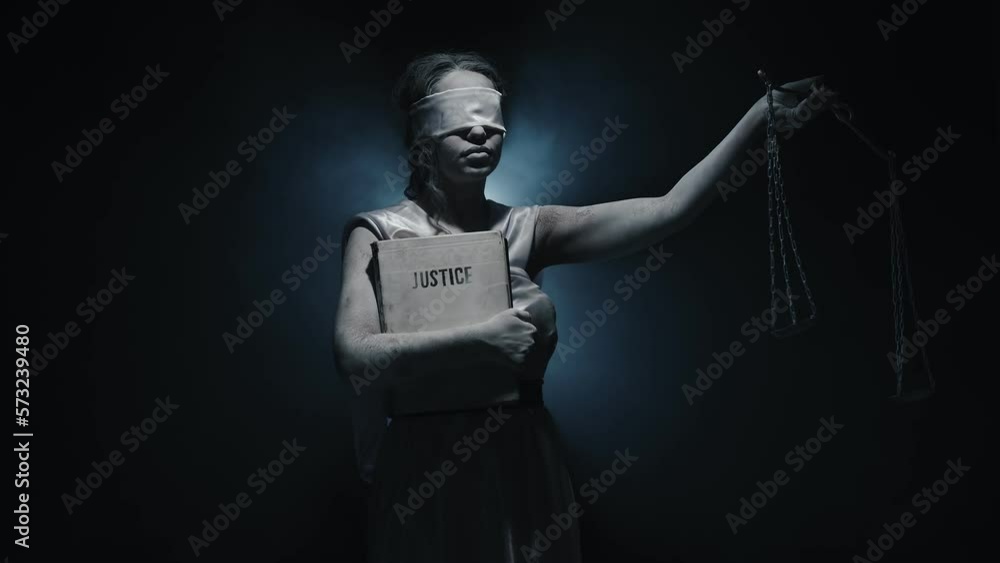 Greek goddess of justice stands on a black background with moving smoke ...