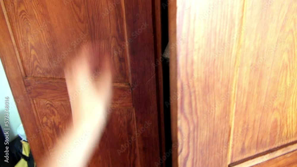 Old chaotic wardrobe closet is opened , examined and searched for items ...