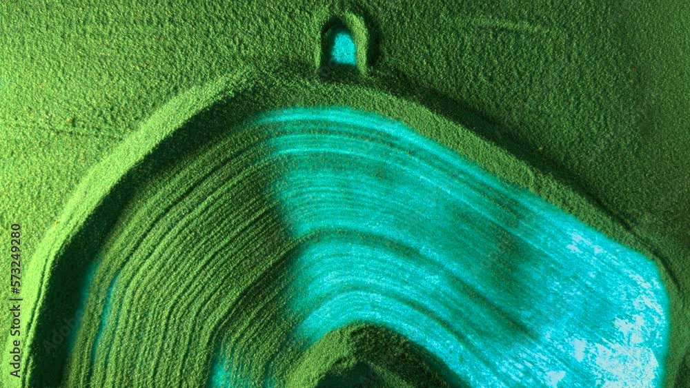 Hand Drawing The Dollar Currency Symbol In The Green Sand And Then hand-drawing-the-dollar-currency-symbol-in-the-green-sand-and-then