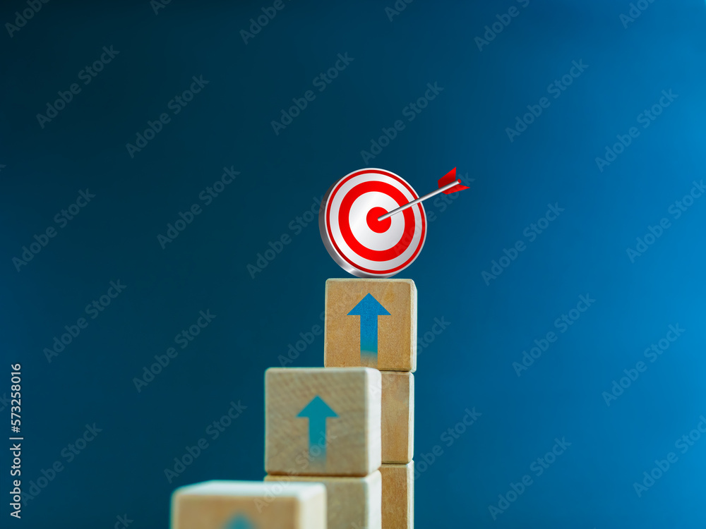 3d target icon on the top of wooden cube blocks, bar graph chart steps ...