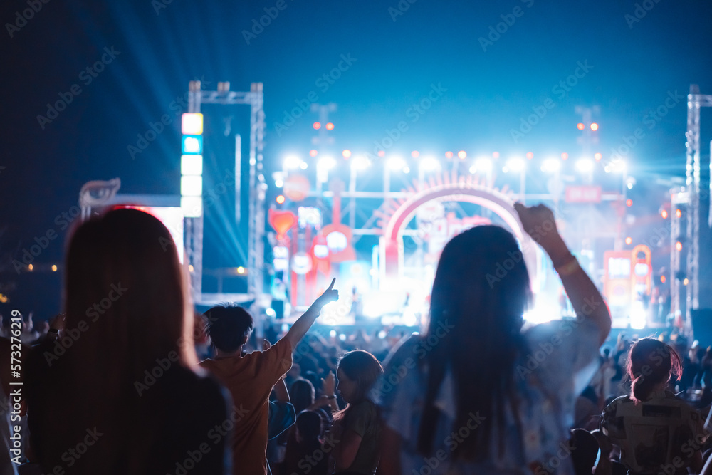 Crowd of hands up concert stage lights and people fan audience ...