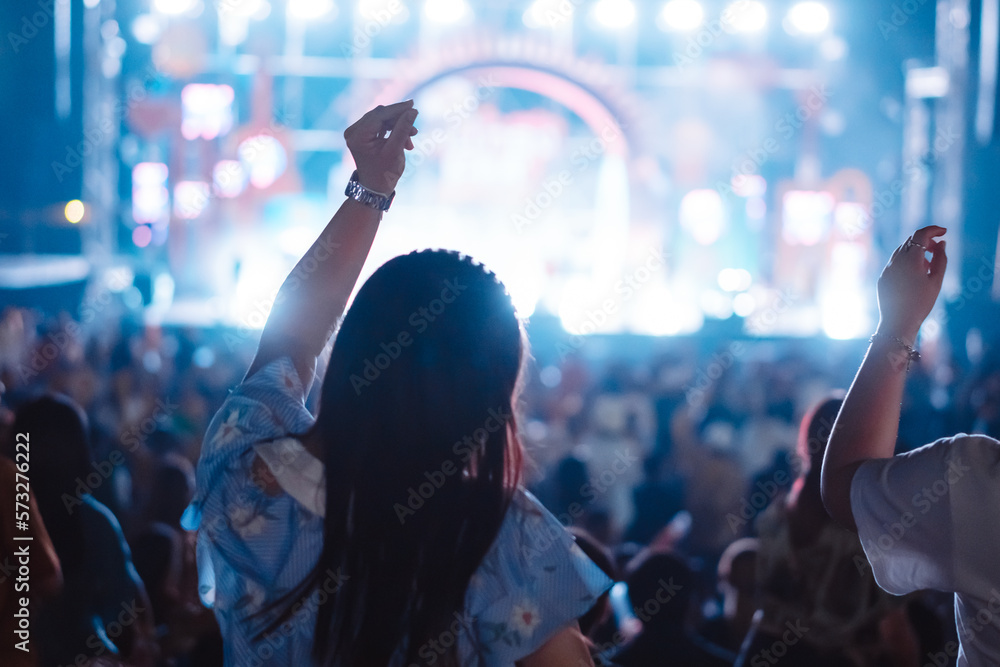 Crowd of hands up concert stage lights and people fan audience ...