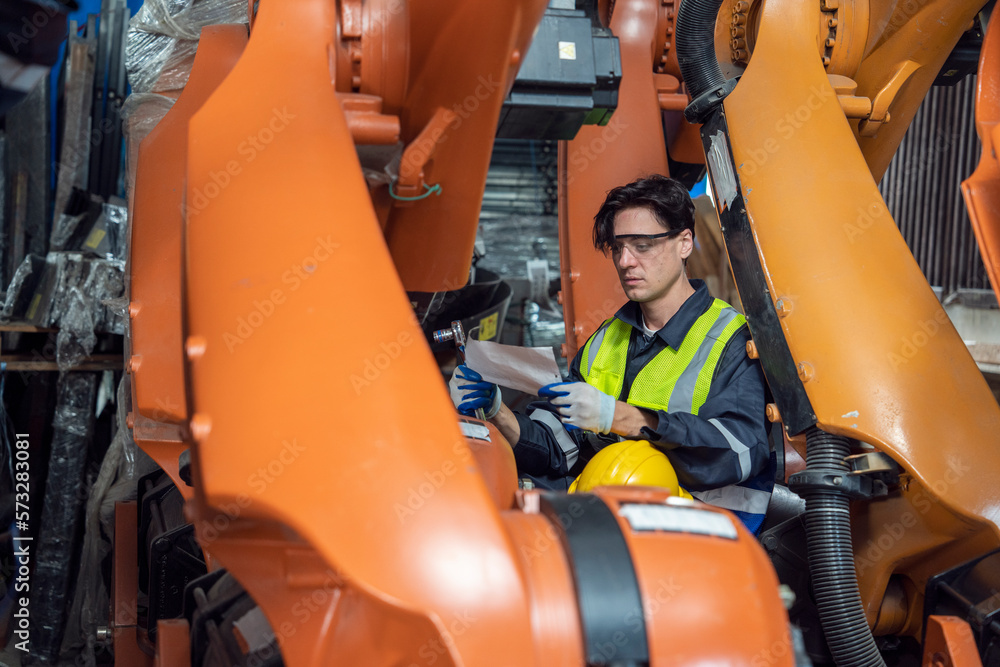 Male engineer holding a walkie-talkie radio wearing a safety uniform ...