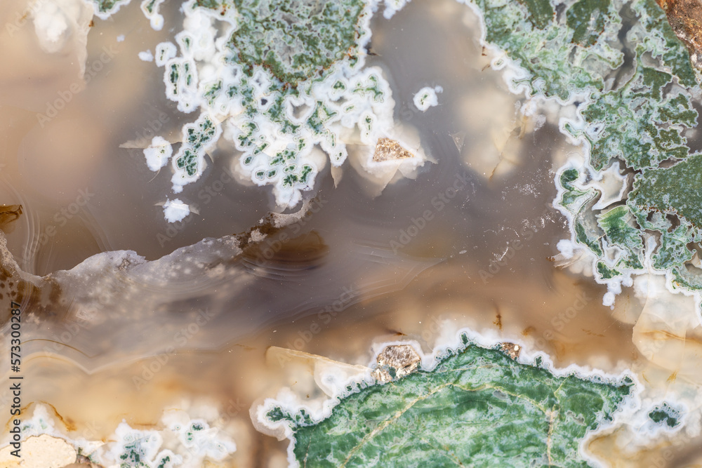 Agate mineral stone with a milky surface and green inclusions which ...