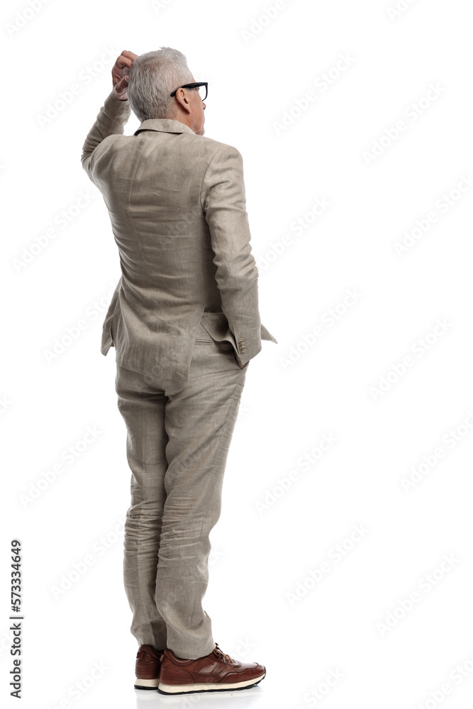 behind view of old man in his 60s scratching head and thinking Stock ...