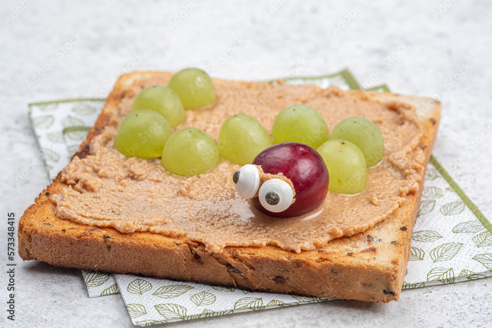 Funny worm sandwich toast with peanut butter and green grapes Stock ...