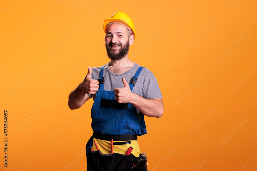 Successful repairman giving thumbs up on camera, showing like and ...