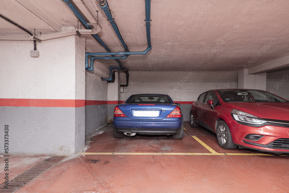 Parking spaces marked out with yellow paint on the ground floor of a ...