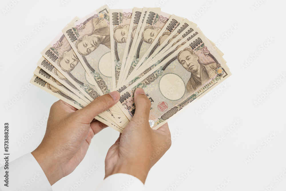 man hand holding Japanese Yen banknote stack. Thousand Yen money. Japan ...