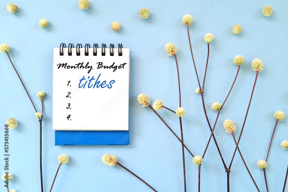 Tithe and offering as part of budget priority concept. Notepad with ...